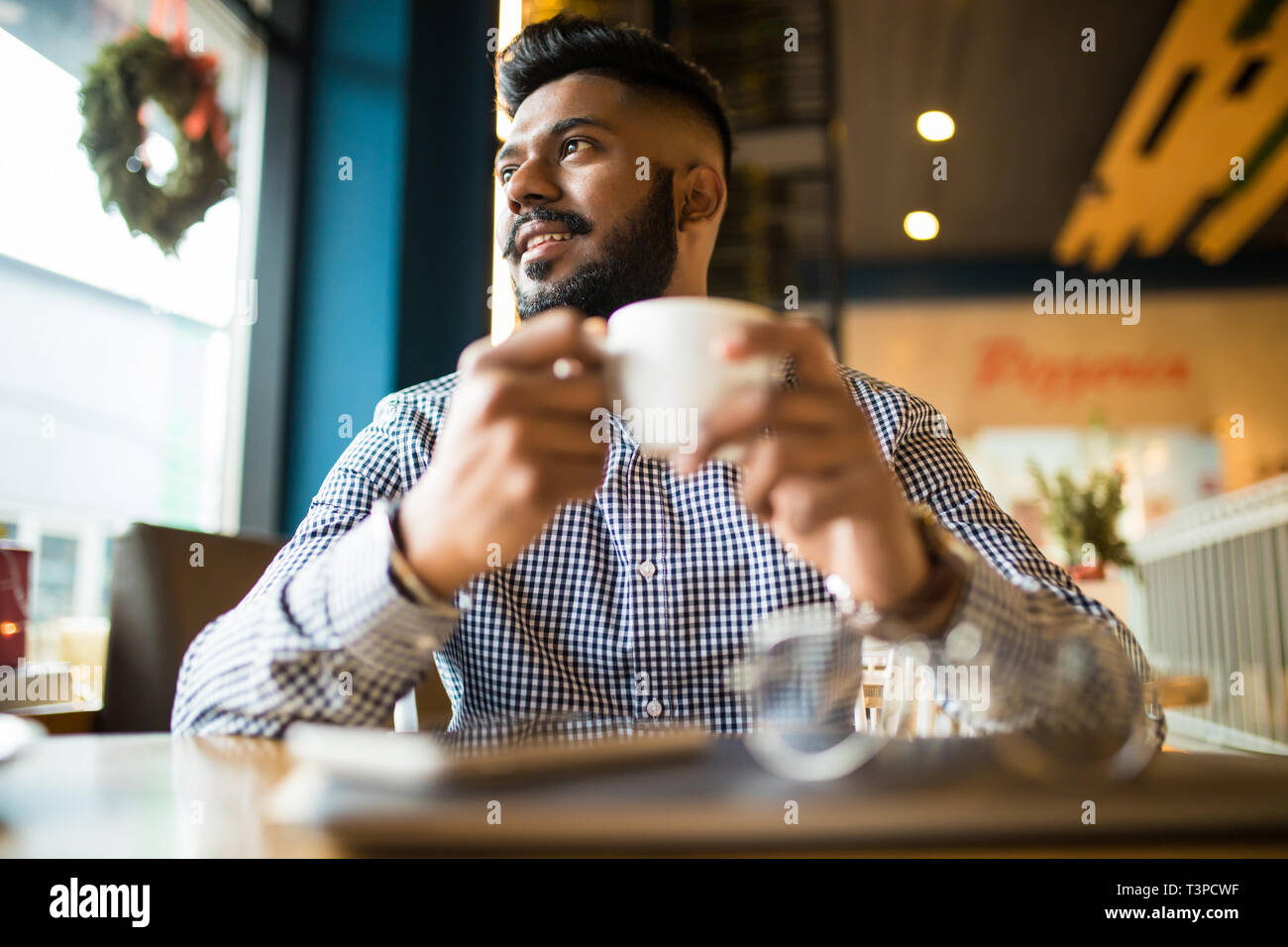 Man using laptop computer while drinking a cup hot milk tea, outdoor ...