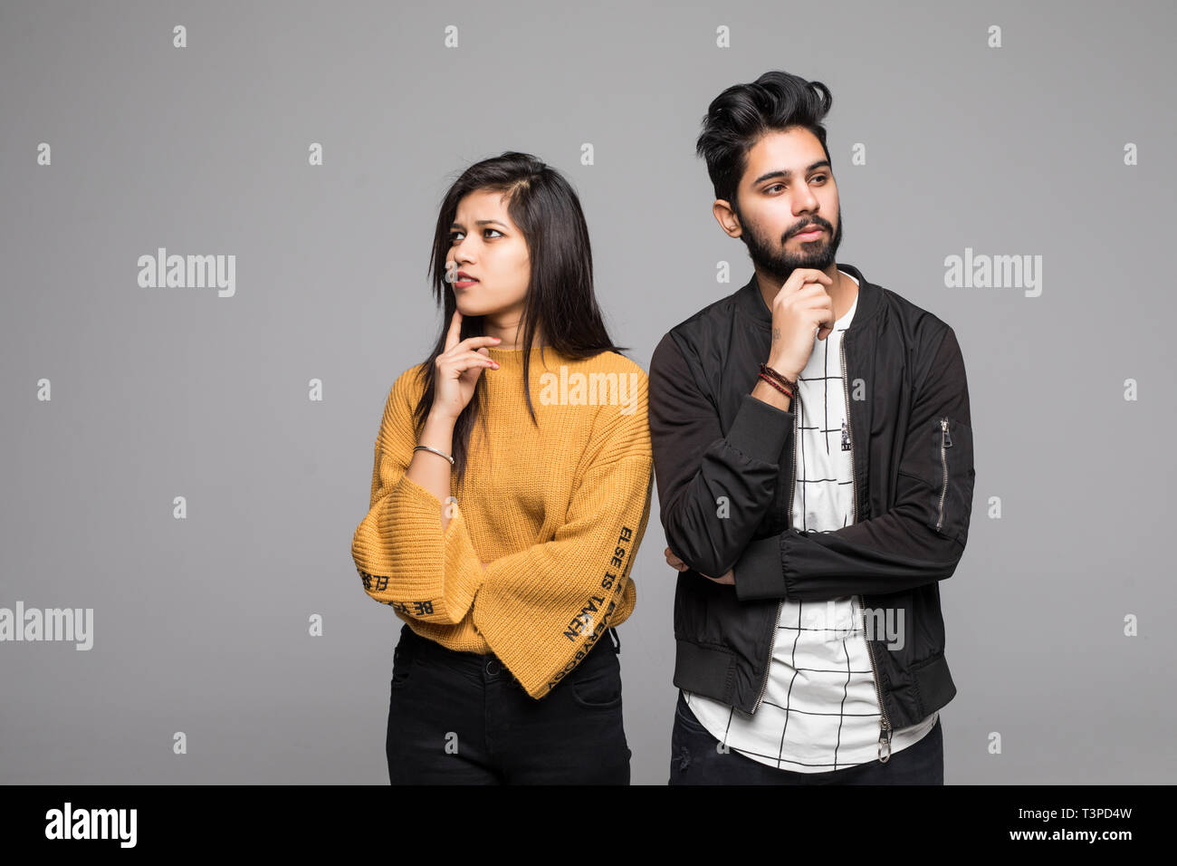 Portrait of serious thinking young loving indian couple isolated over ...