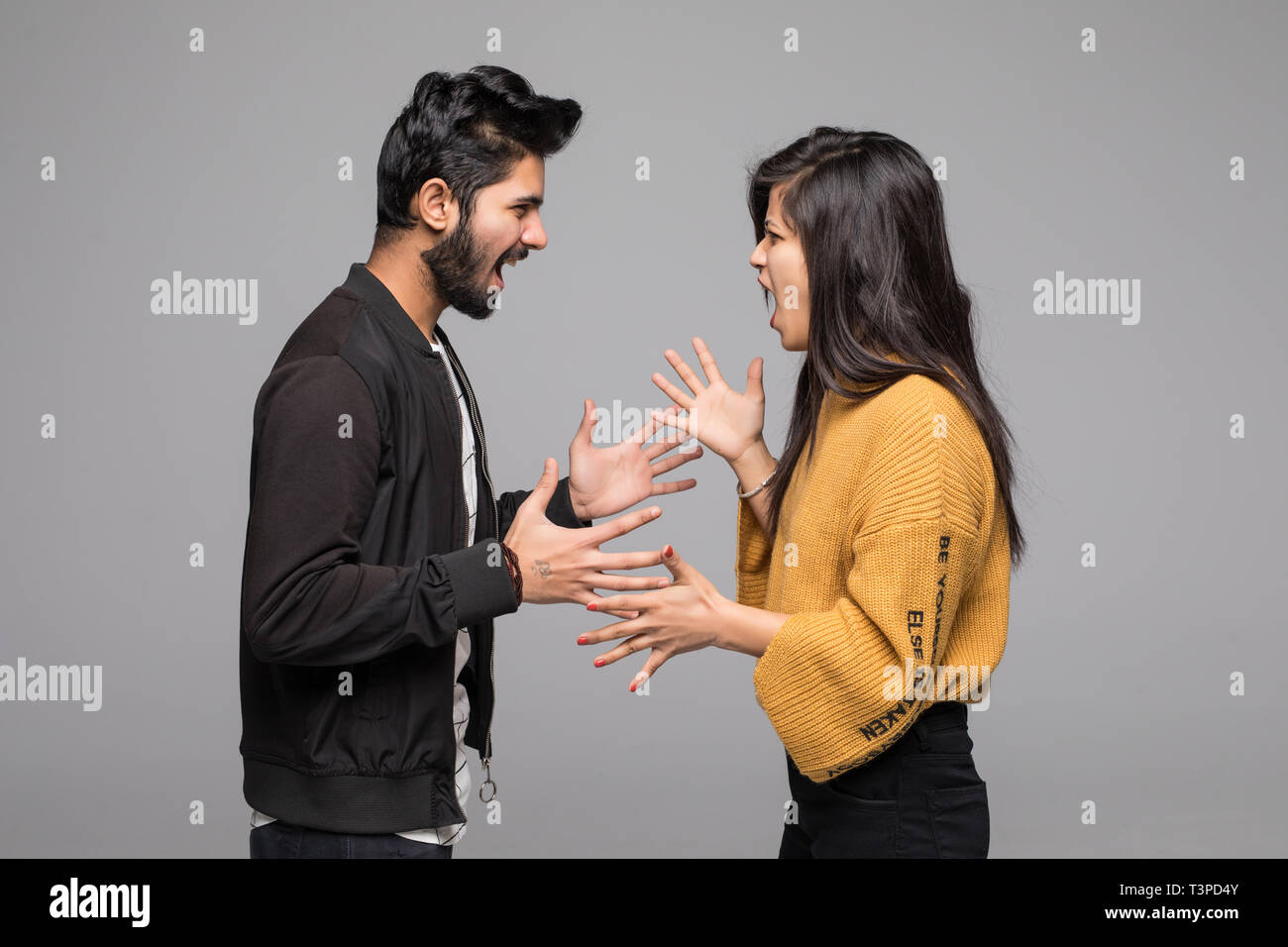 emotional young couple quarreling isolated on white Stock Photo - Alamy