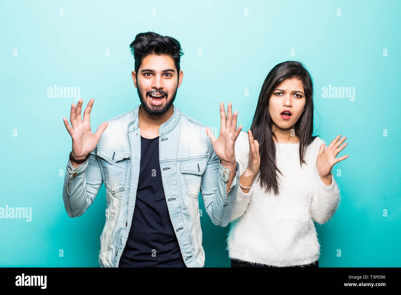 Indian couple scream surprised on green background Stock Photo - Alamy