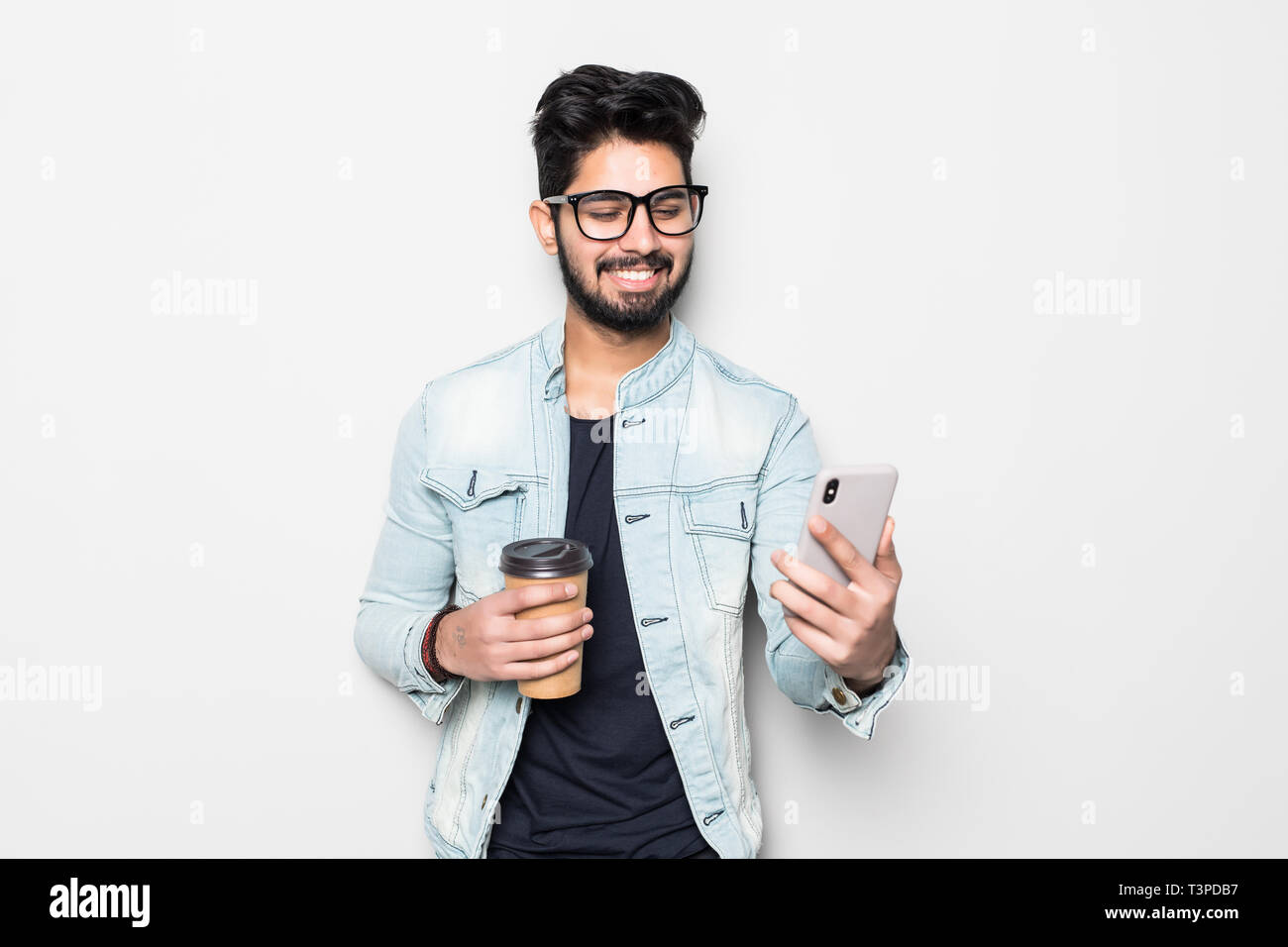 Portrait of young Indian man making video call from the phone isolated ...