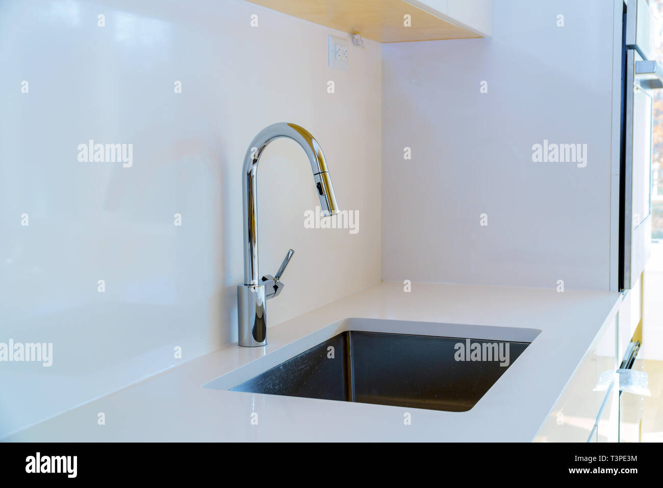 New modern white kitchen with built chrome water tap Stock Photo - Alamy