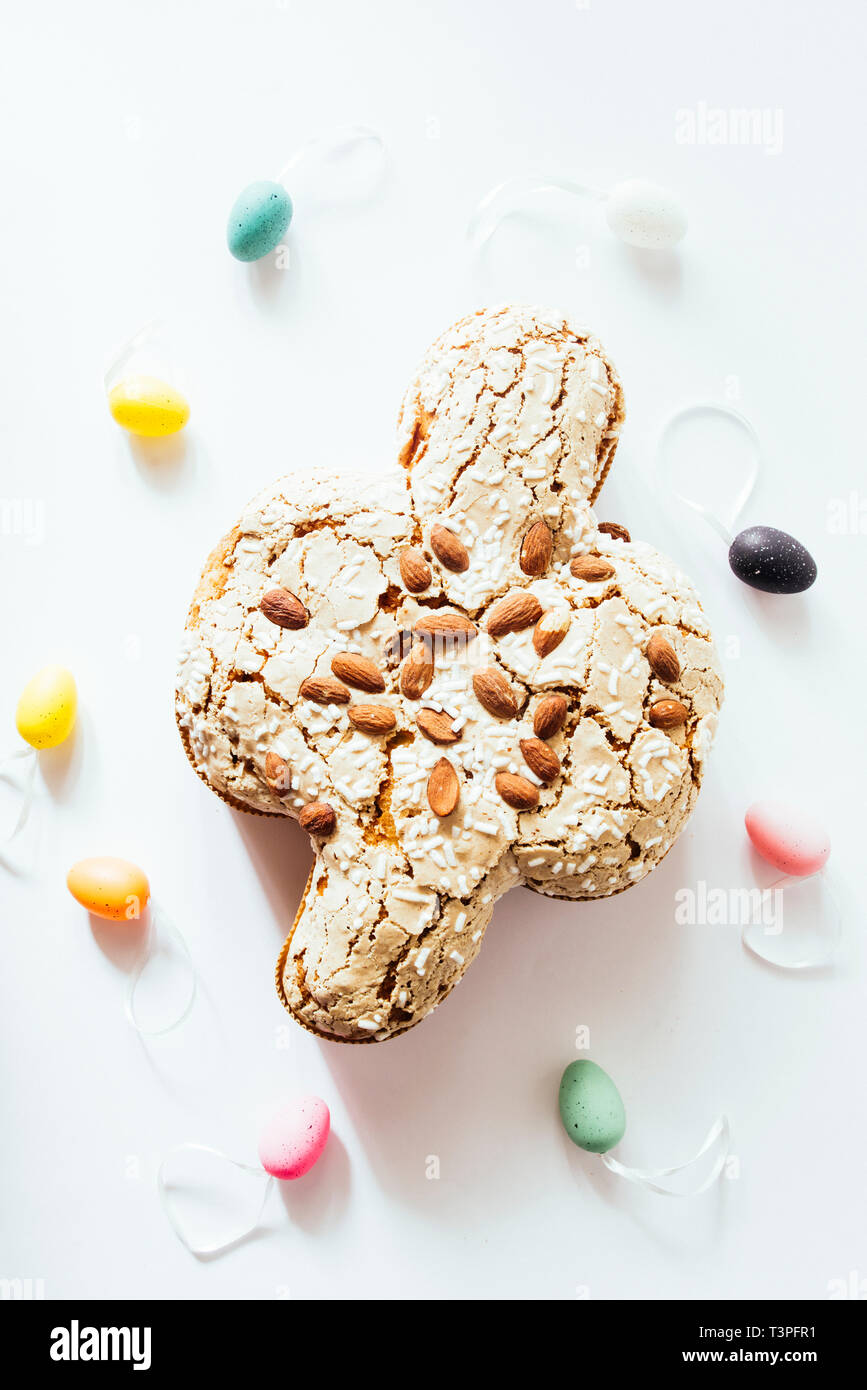 Colomba pasquale , dove, with multi colored eggs and on a white ...