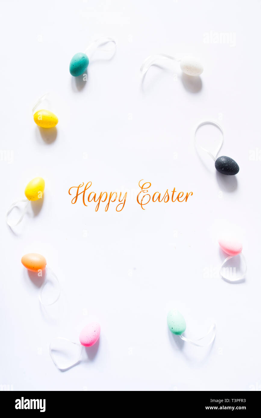 Colorful small eggs arranged in a circle egg shaped on a white ...
