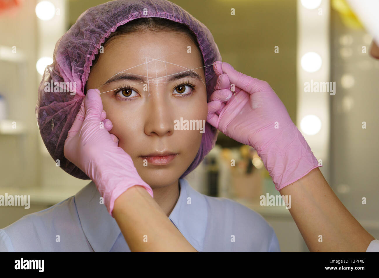 Microbleeding and eyebrow architecture. Beautician forms contour and ...