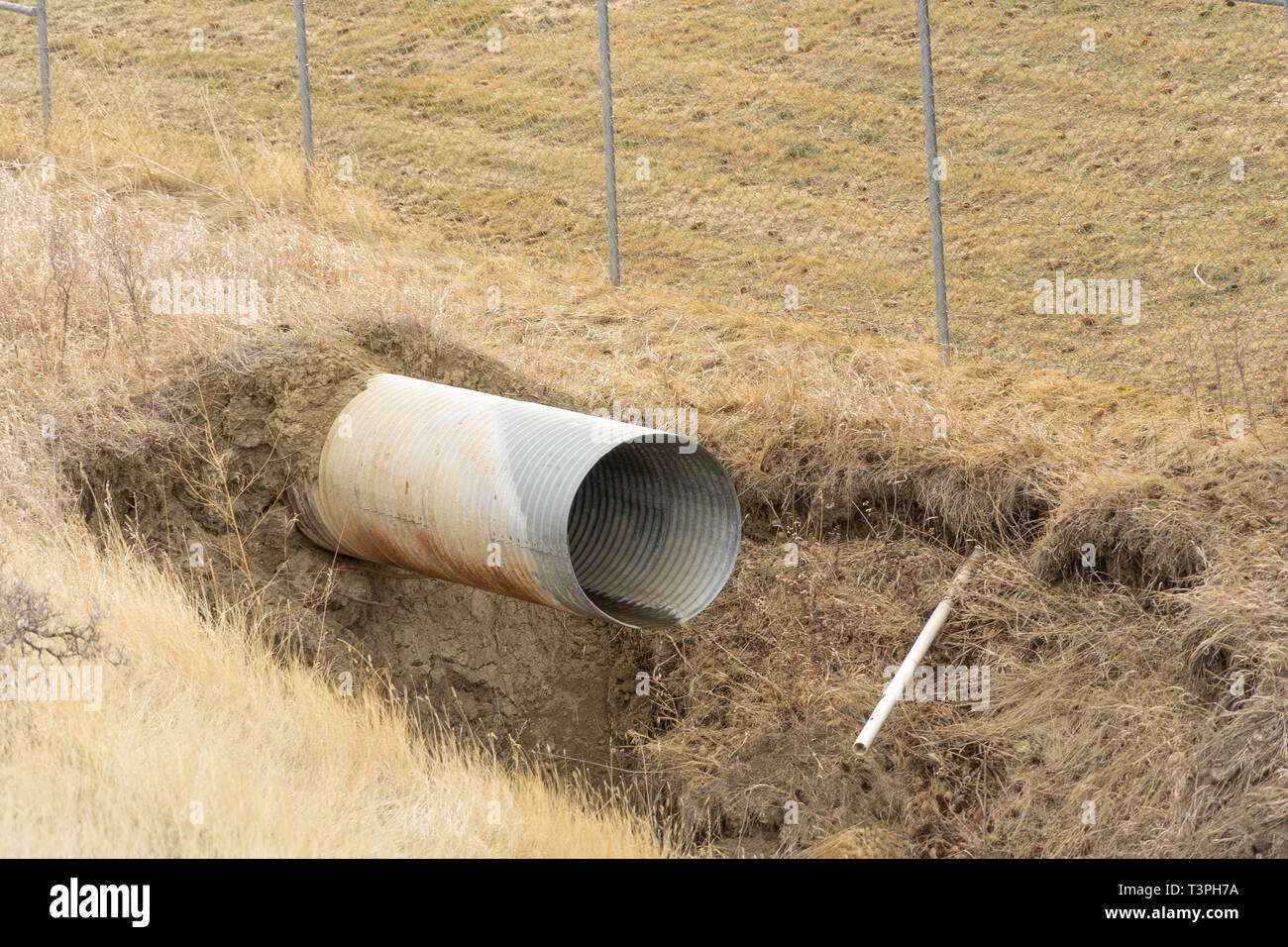 Polluted water flowing out of pipe into stream or river hi-res stock ...