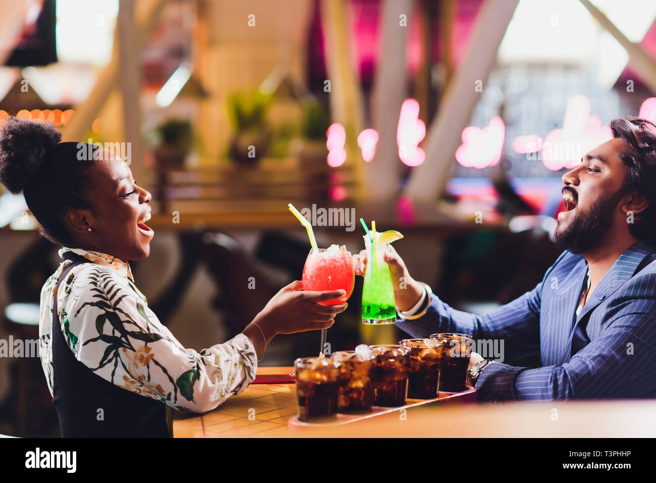 young people sitting in a cafe and talking. Young man and woman meeting ...