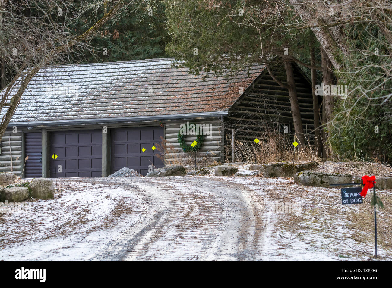 Winter Scene featuring cabin in the woods with snow covered driveway ...