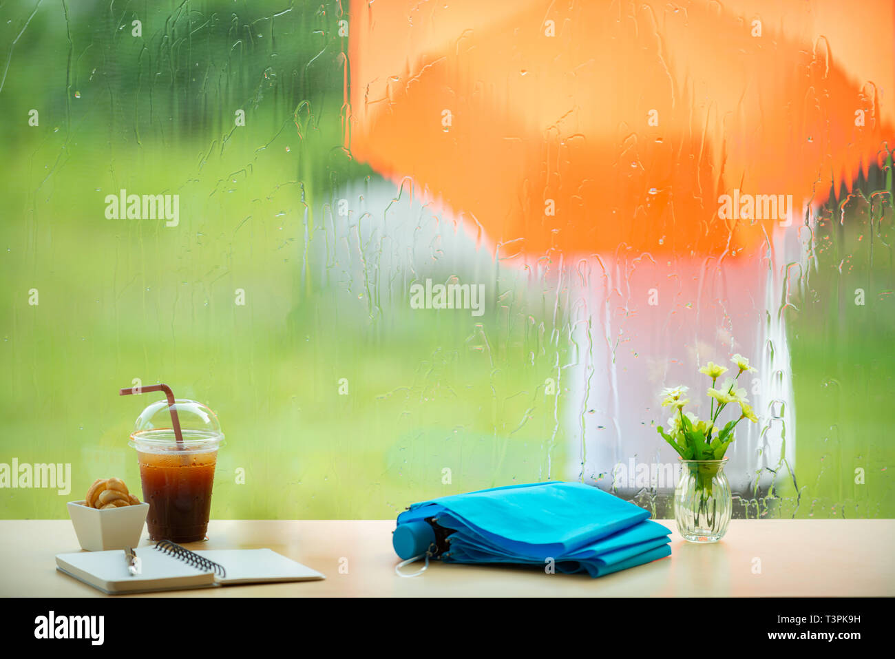 an umbrella over the window of a rainy cafe. an emotional mood Stock ...