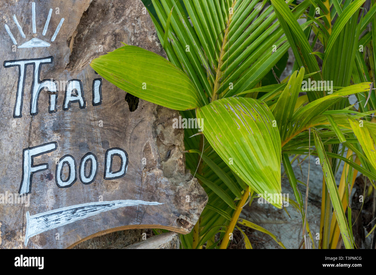 a handmade painted sign advertising thai food on ko phangan in the gulf ...