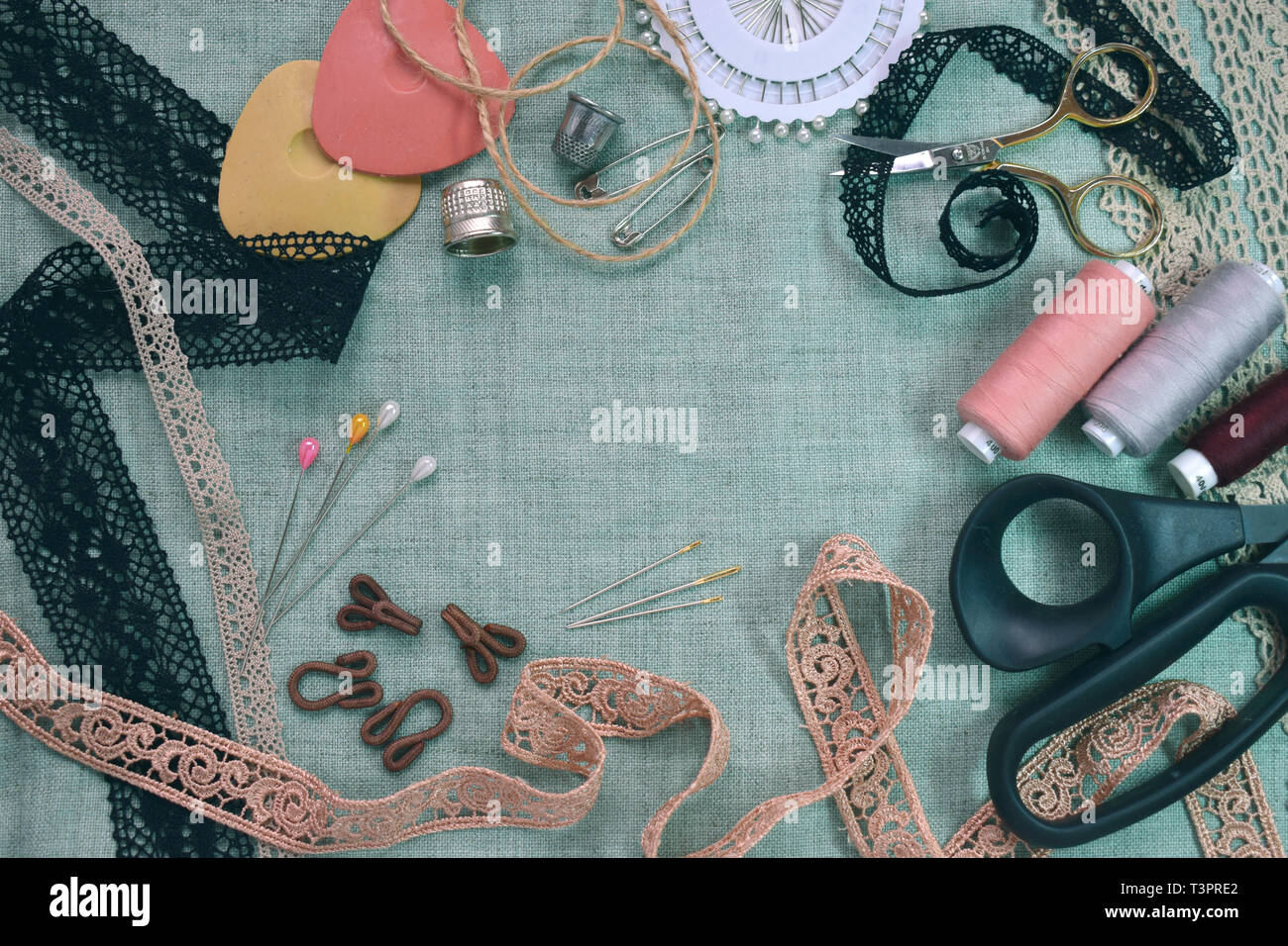 Sewing scene table flat lay composition. Threads, lace, pins, scissors ...
