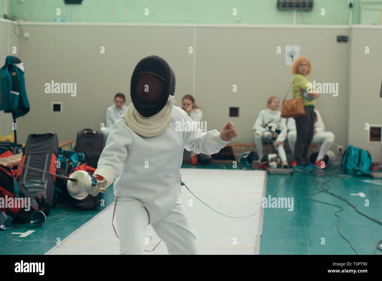 A girl fencer having fencing duel on tournament Stock Photo - Alamy