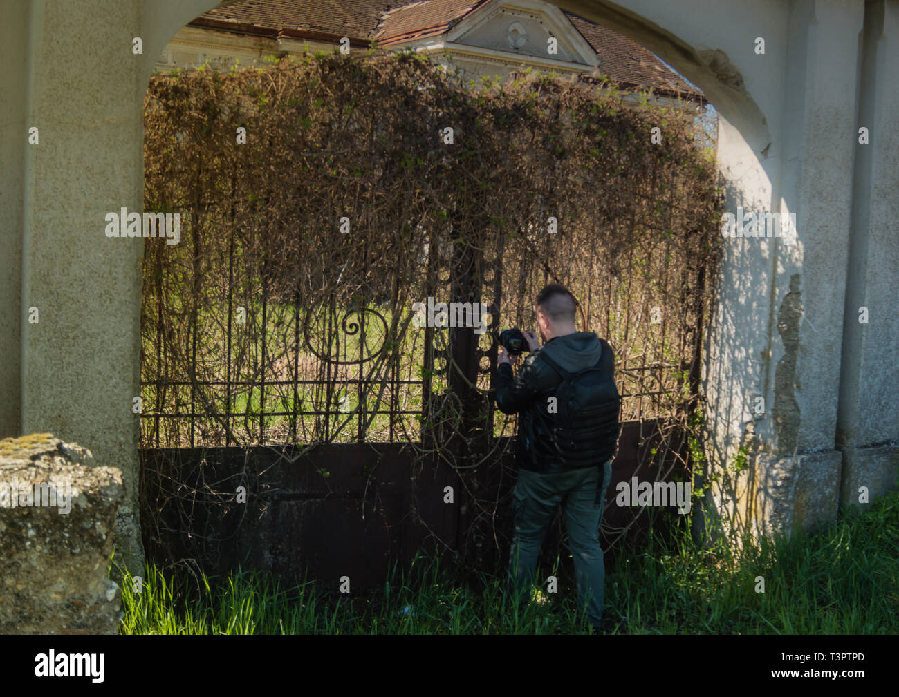 Man taking pictures in location with camera and exploring abounded ...