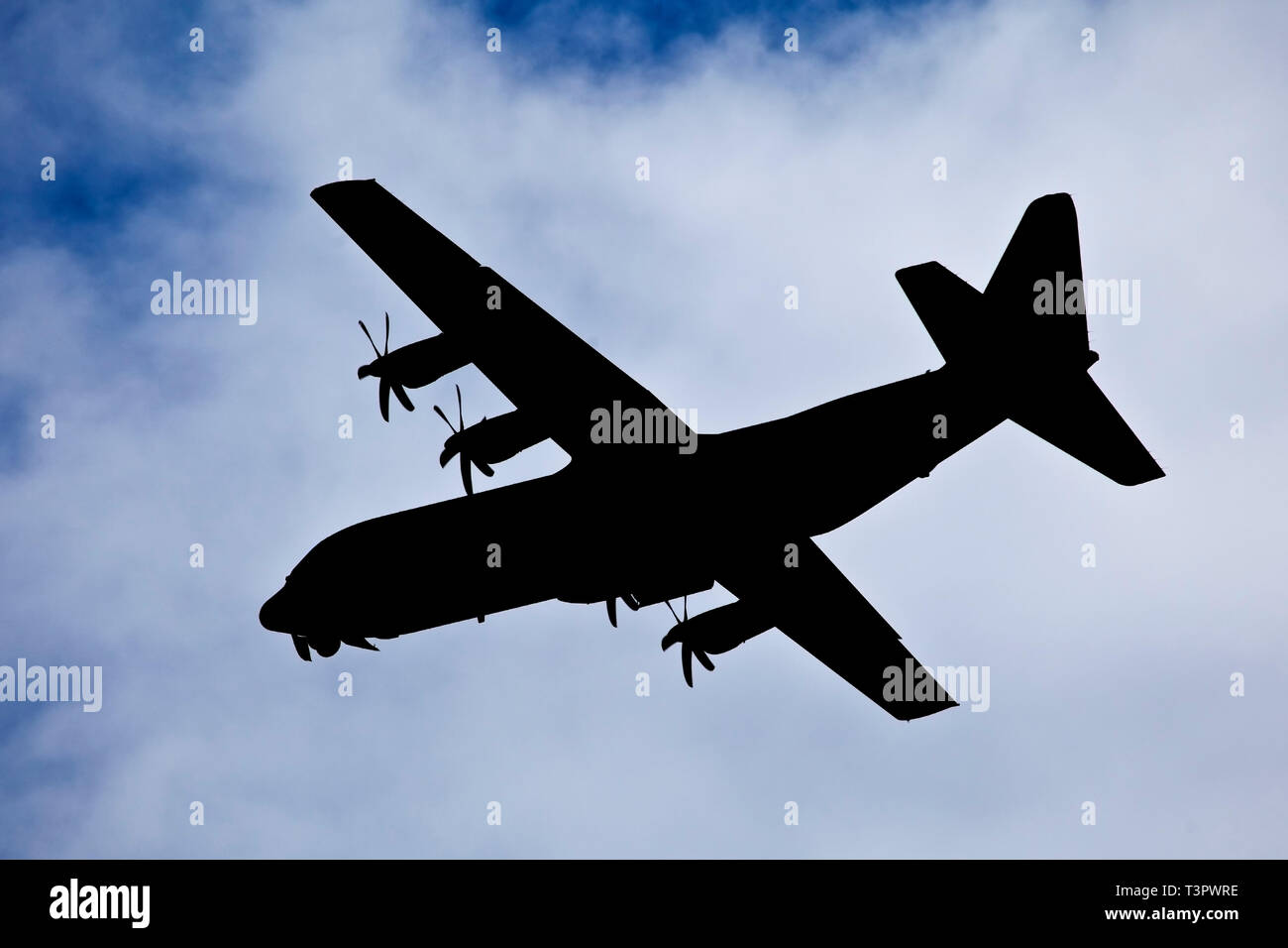 Silhouette of an RAF Hercules C-130 transport aircraft seen from below ...