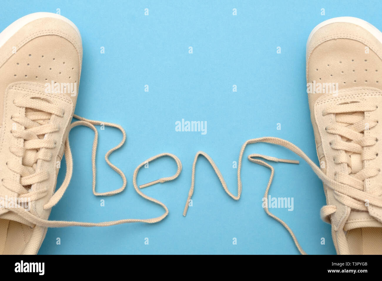 Women sneakers with laces in bent text Stock Photo - Alamy