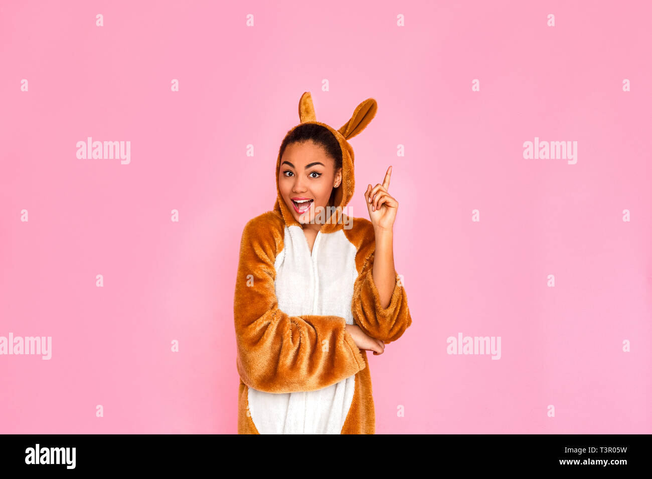 Young Woman In Bunny Kigurumi Standing Isolated On Pink Background