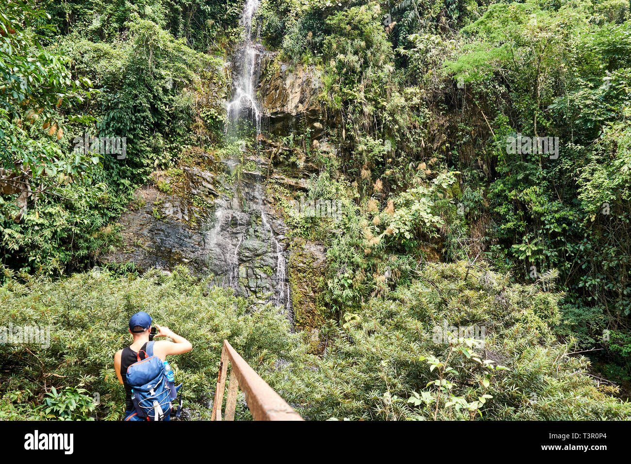 Man watching waterfall at holiday in Vang Vieng , Loas Stock Photo - Alamy