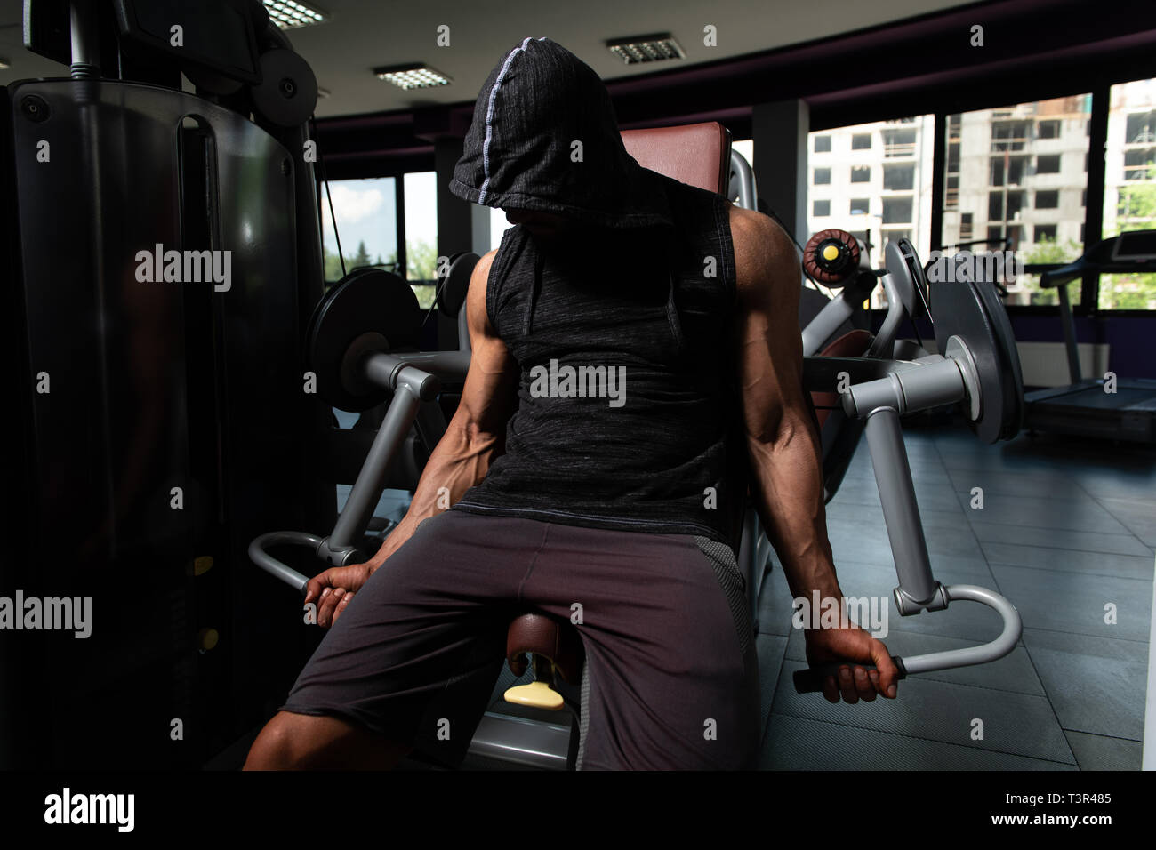 Muscular Fitness Bodybuilder in Hoodie Doing Heavy Weight Exercise For ...