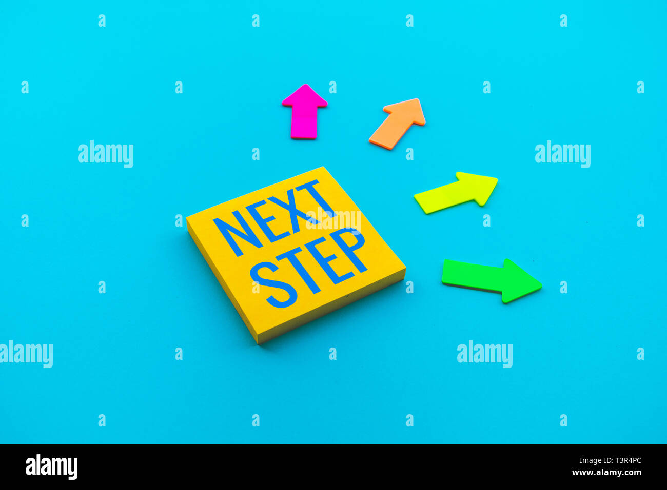 Next step concepts with text on notepaper and direction of arrow ...
