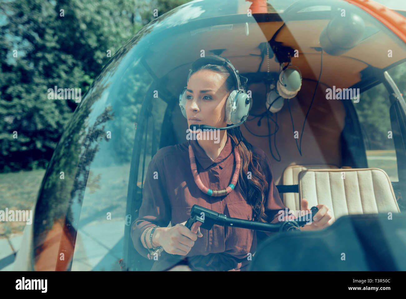 Concentrated good-looking female pilot wearing needed equipment Stock ...