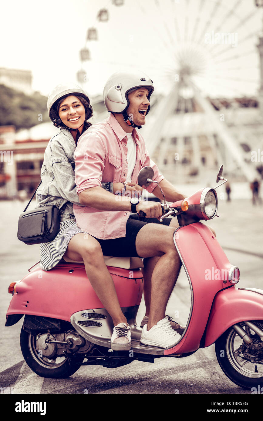 Nice happy young man riding a motorcycle Stock Photo - Alamy