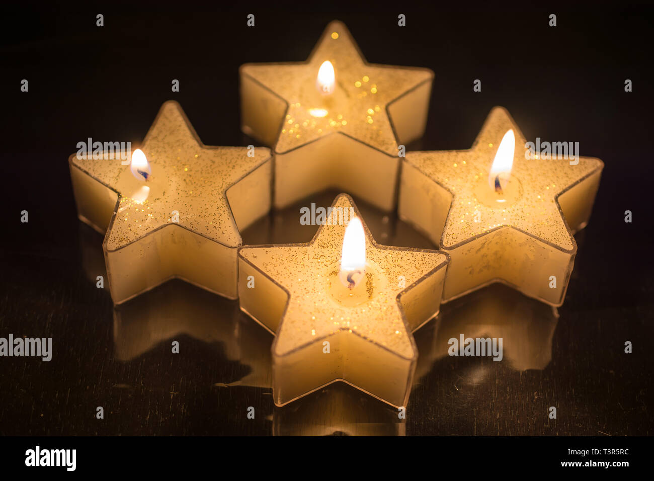 Four star shaped candles were lit for the fourth advent Stock Photo - Alamy