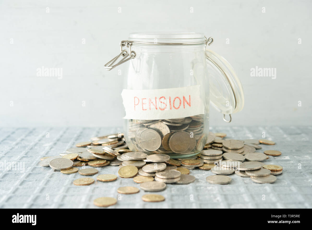 Coins in glass money jar with pension label, financial concept Stock ...