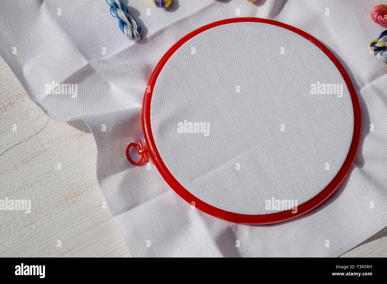 The embroidery hoop with canvas and bright sewing threads Stock Photo ...