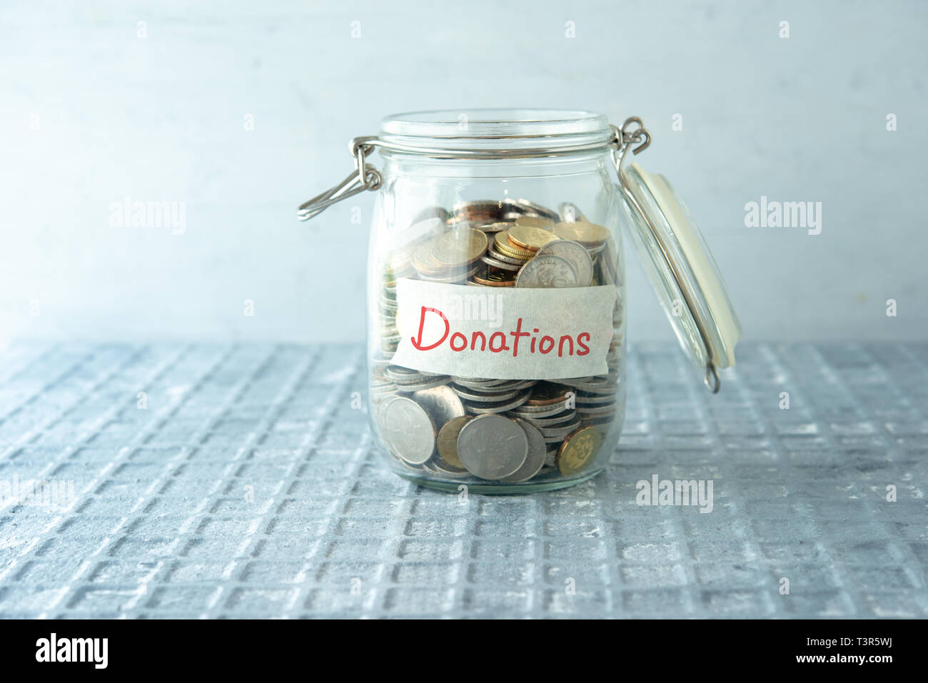 Coins in glass money jar with donations label, financial concept Stock ...