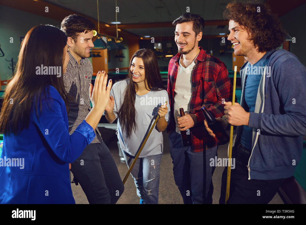 Group of friends laughing in the billiard club Stock Photo - Alamy