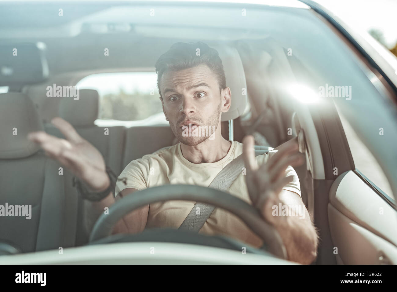 Emotional young male person wrinkling his forehead Stock Photo - Alamy