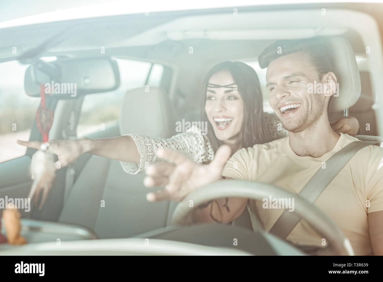Cheerful young people looking in one direction Stock Photo - Alamy