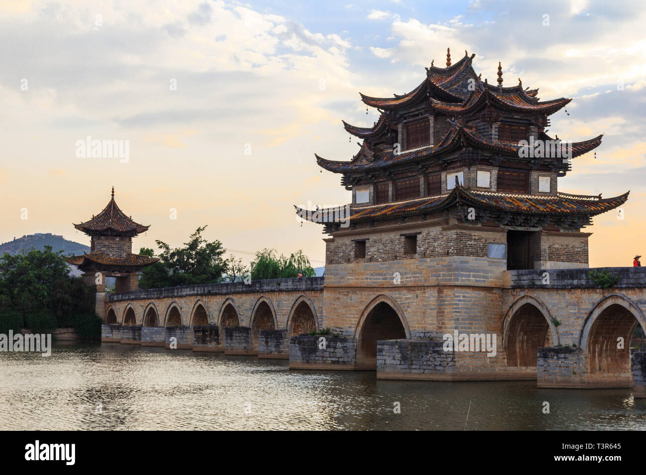 Oriental style stone bridge on a river in China Stock Photo - Alamy