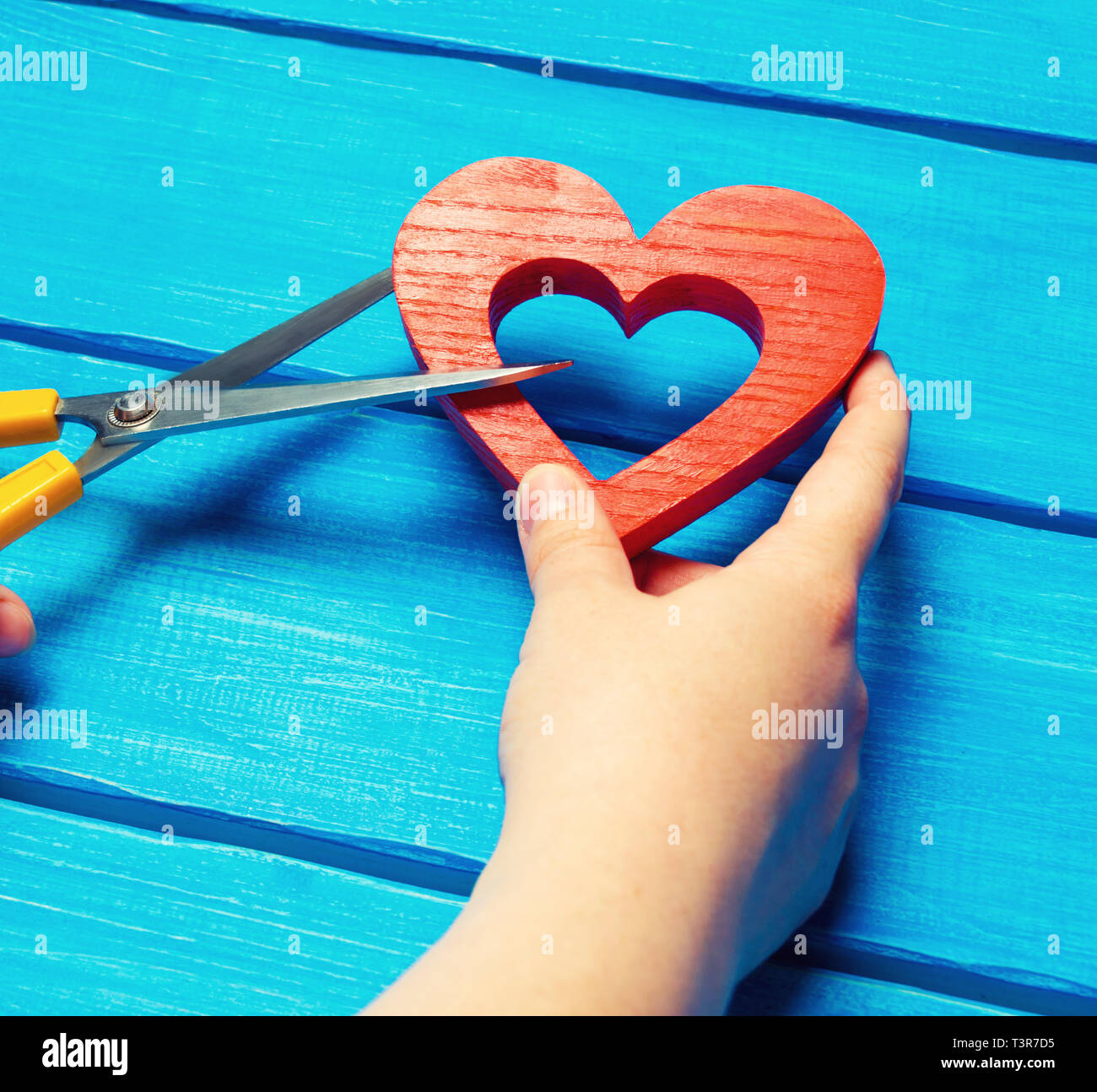 girl cuts the heart with scissors, the concept of breaking relations ...