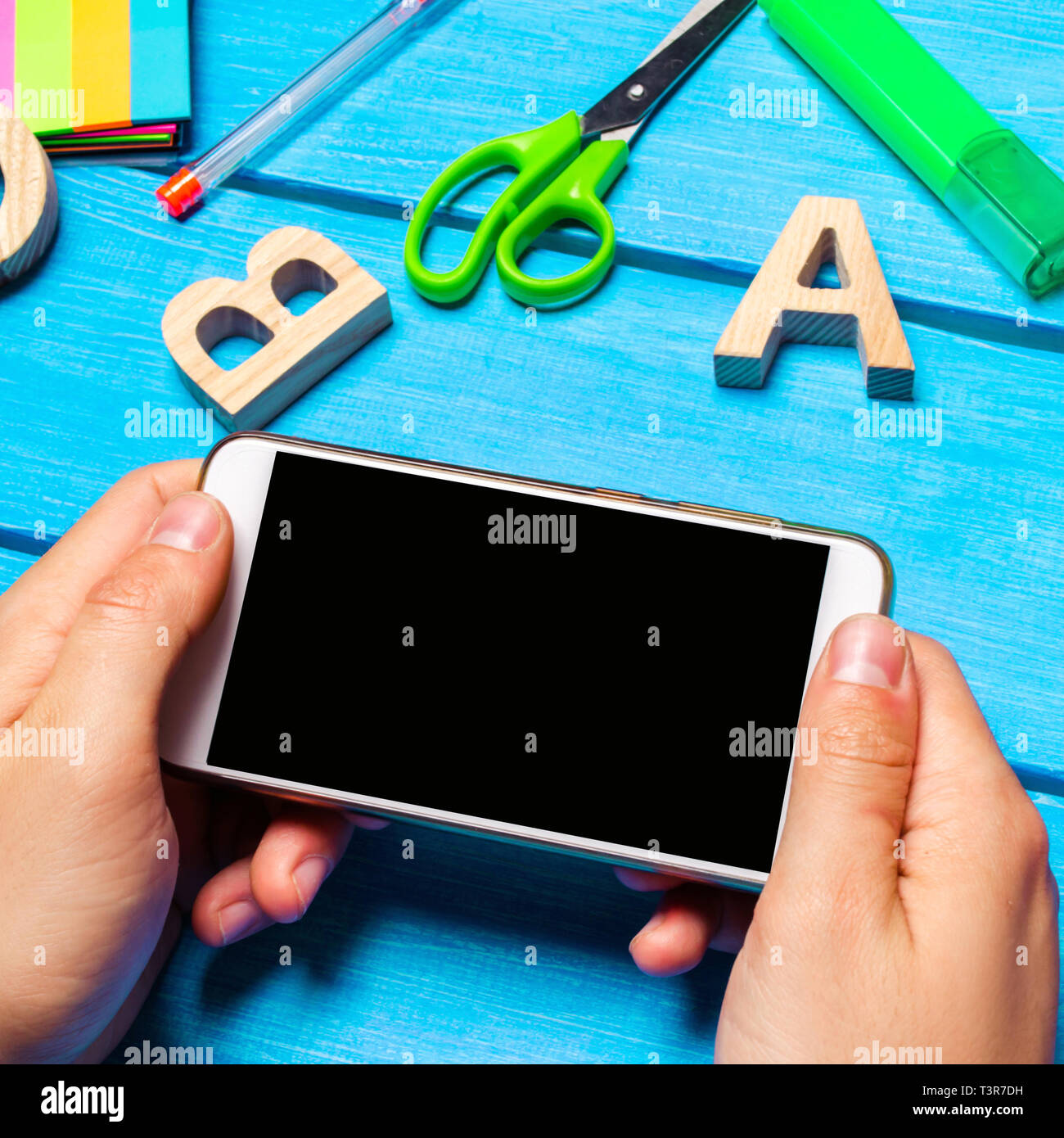 The student is holding a mobile phone in the background of a creative ...