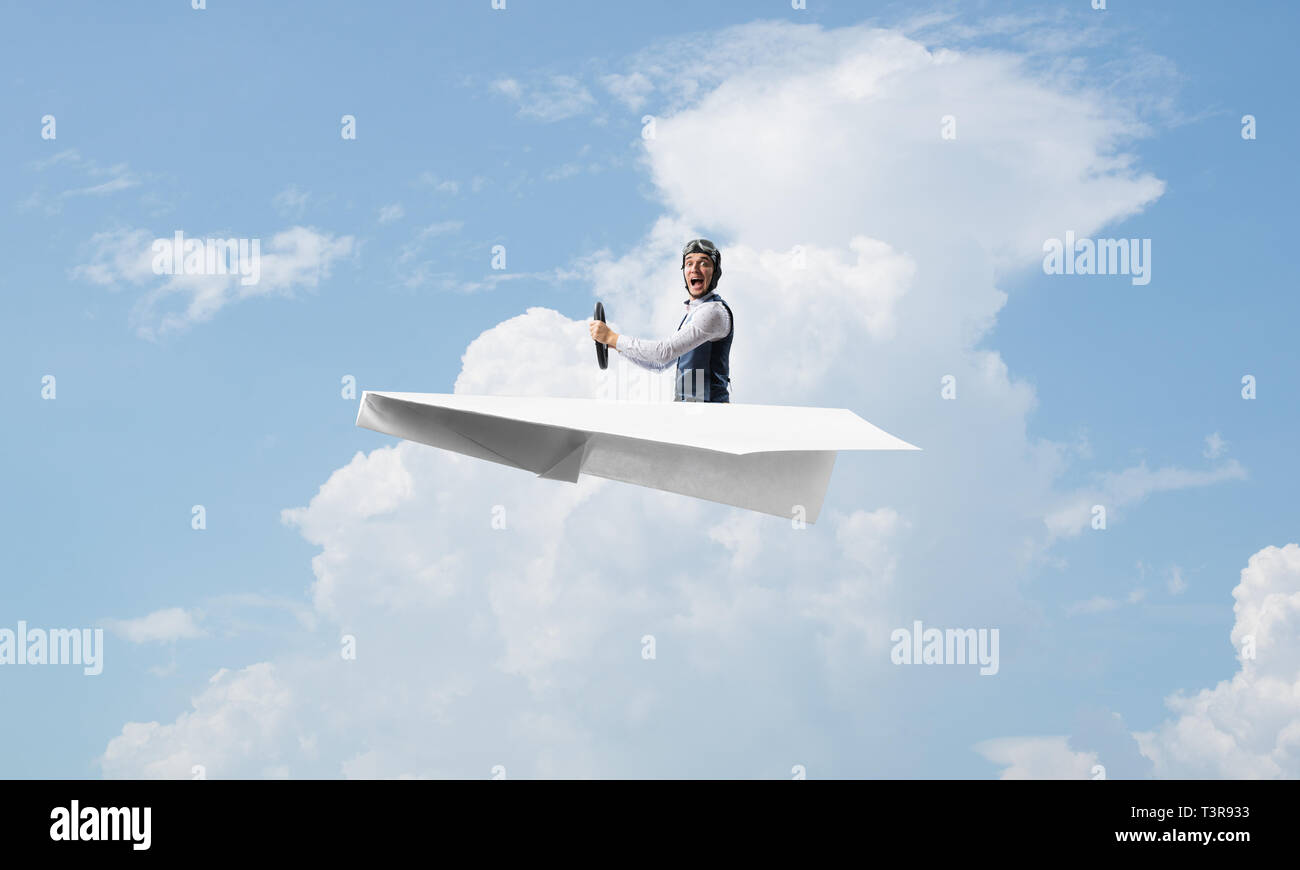 Pilot in leather helmet driving paper plane Stock Photo - Alamy