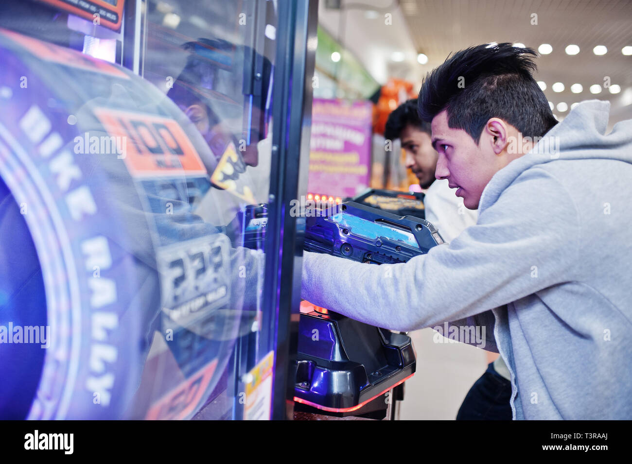 Two asian guys compete on shooter simulator game arcade machine Stock ...