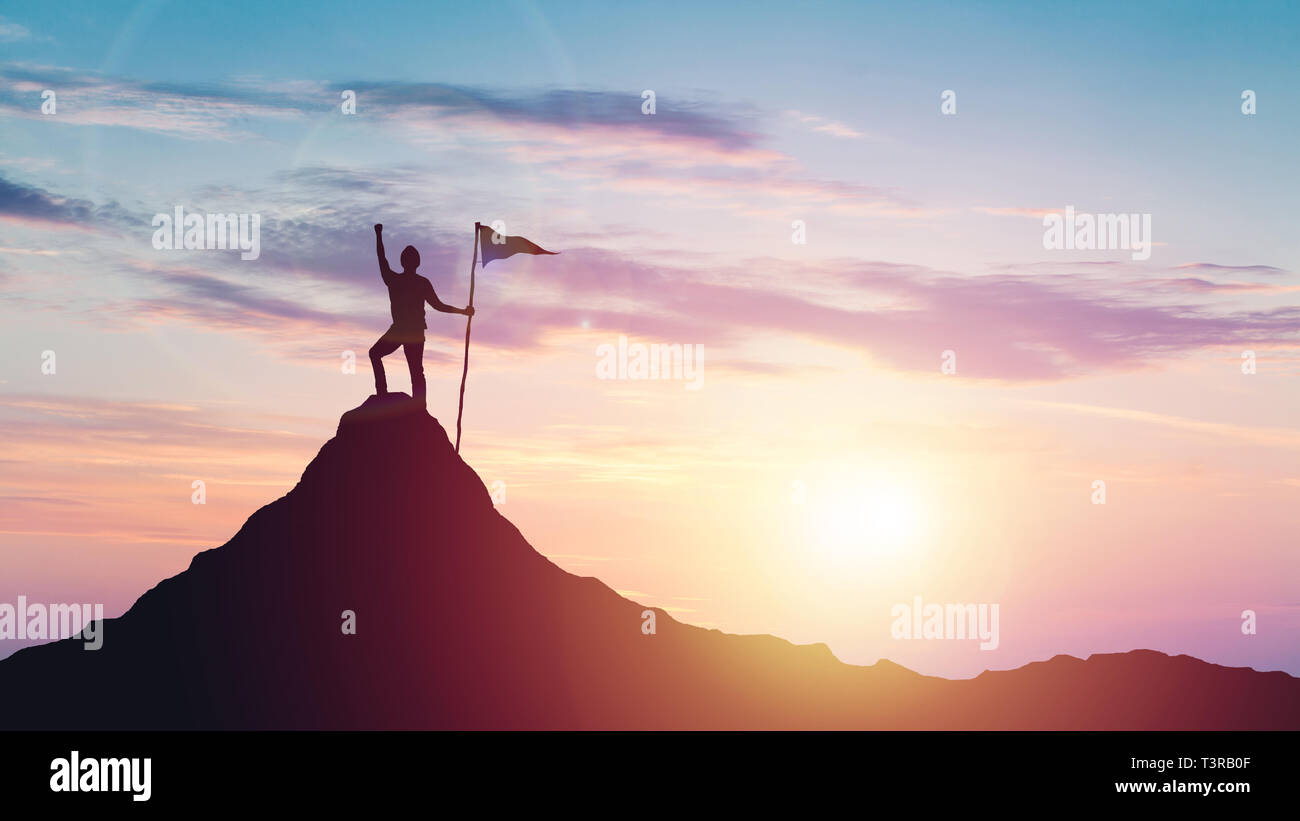 Man with flag celebrates victory on top of a mountain at sunset ...
