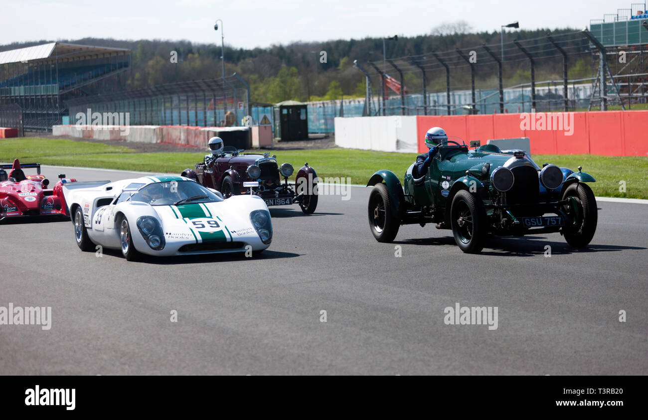 Race cars from different eras parade around the track, during the 2019 ...