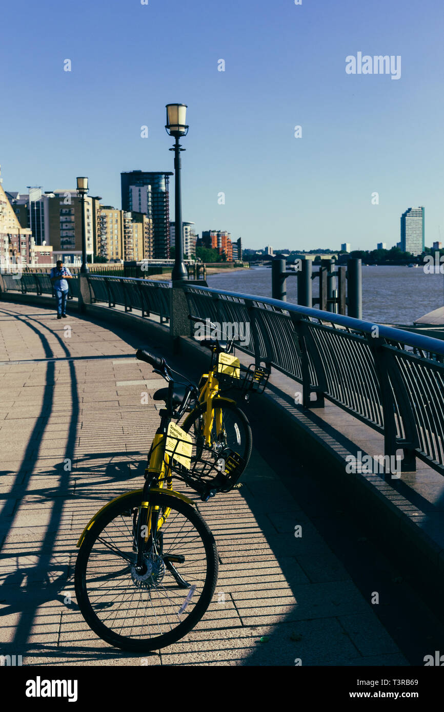 London, UK - July 23, 2018: Yellow Ofo bikes on a street in London. Ofo ...