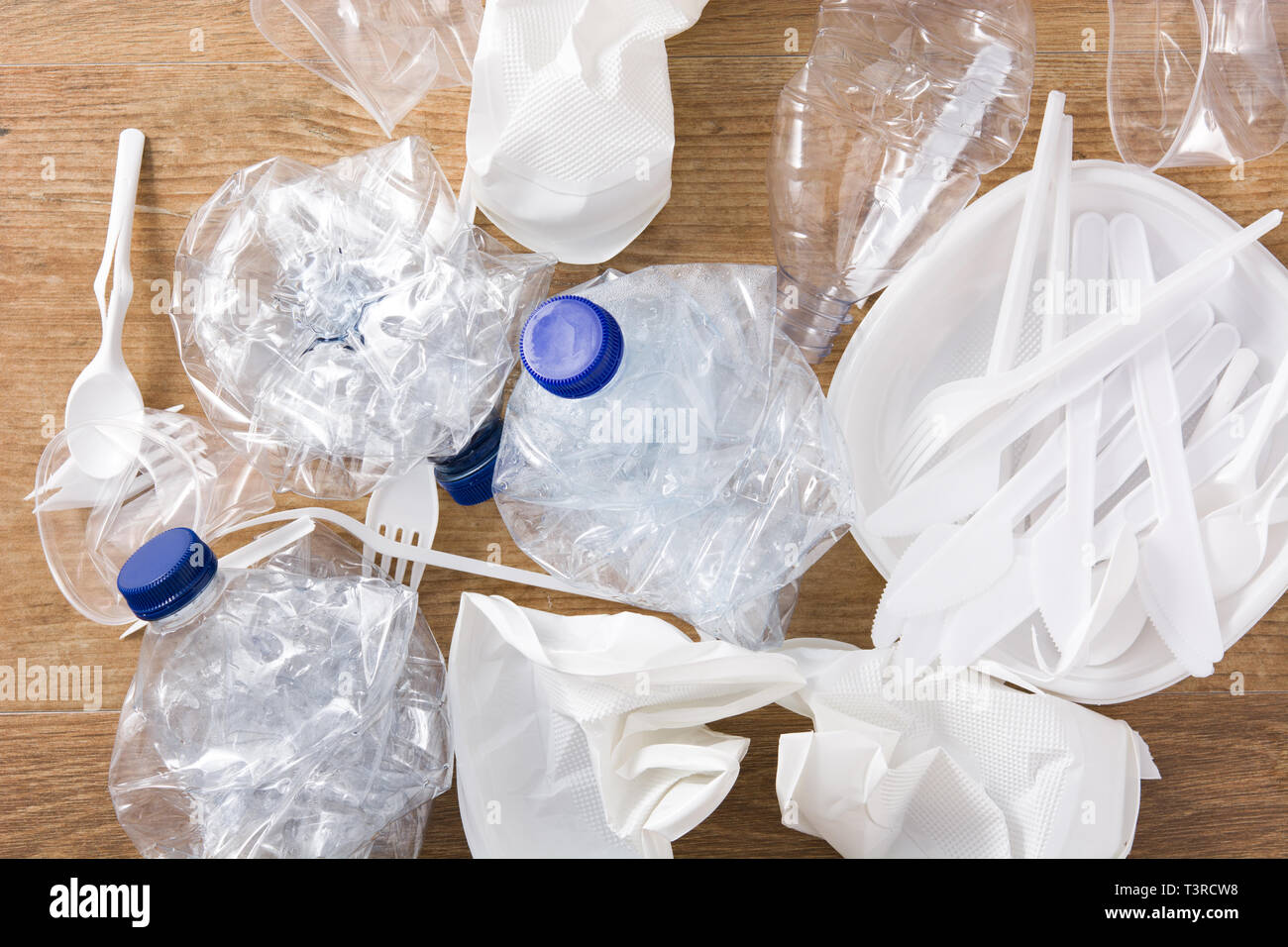 Disposable waste plastic on wooden background. Top view Stock Photo - Alamy