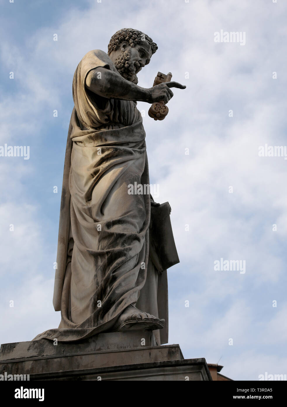 ancient statue of Saint Peter with keys on the hand in the main square ...