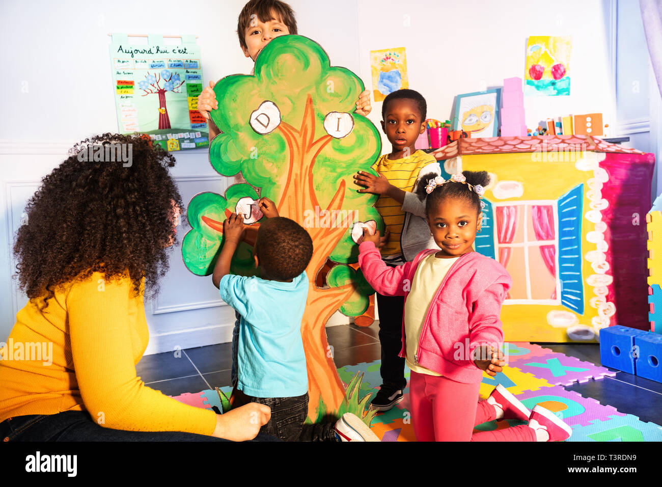 Kids learn alphabet by putting letters on tree Stock Photo - Alamy