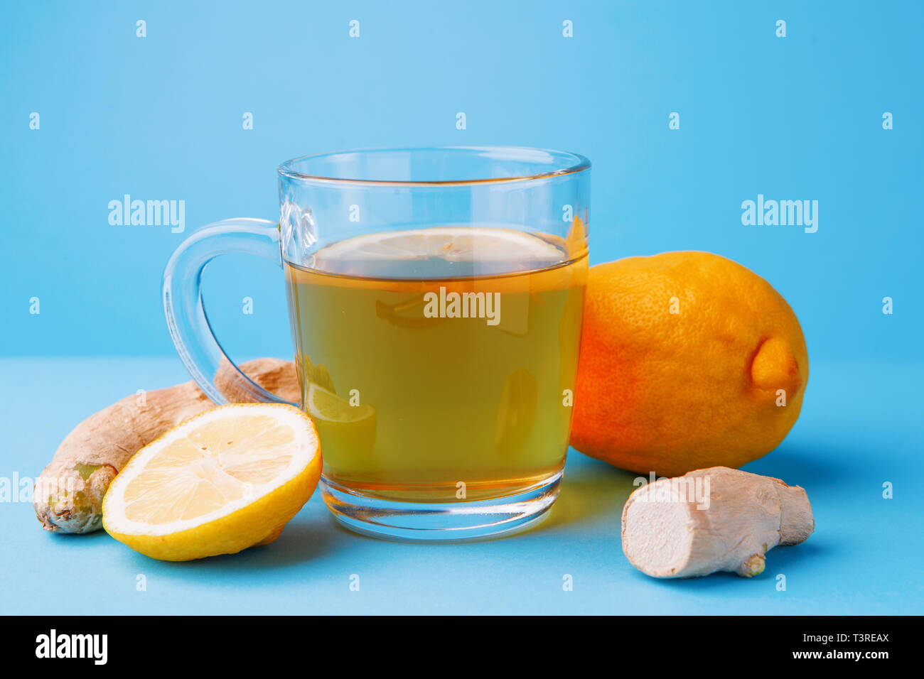 Tea, lemon and ginger on a blue background Stock Photo - Alamy