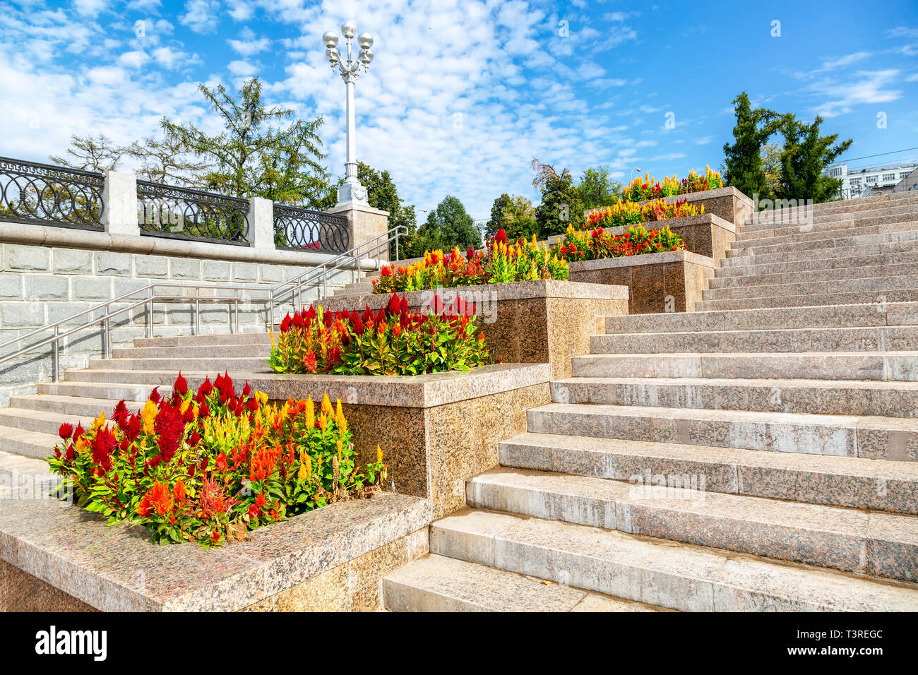 Granite stair with flower beds at the city embankment in sunny day in ...