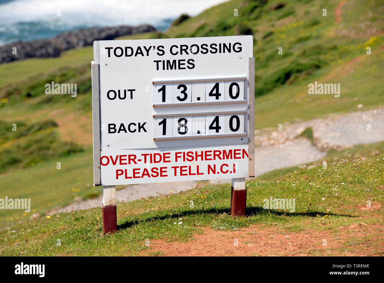 Crossing times sign, Worm's Head, Rhossili Stock Photo - Alamy