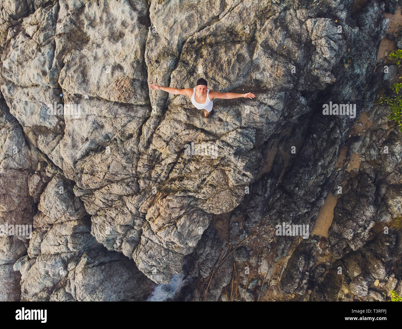 Adventurous man is standing on top of the mountain and enjoying the ...