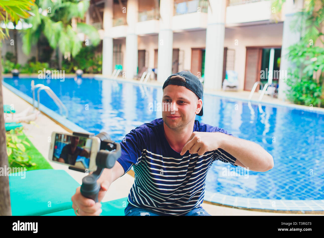 Young male video blogger creates video content for his channel. Video ...