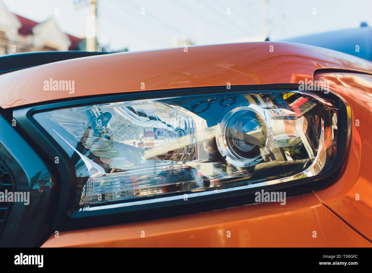 Closeup of car headlight - front view orange body Stock Photo - Alamy