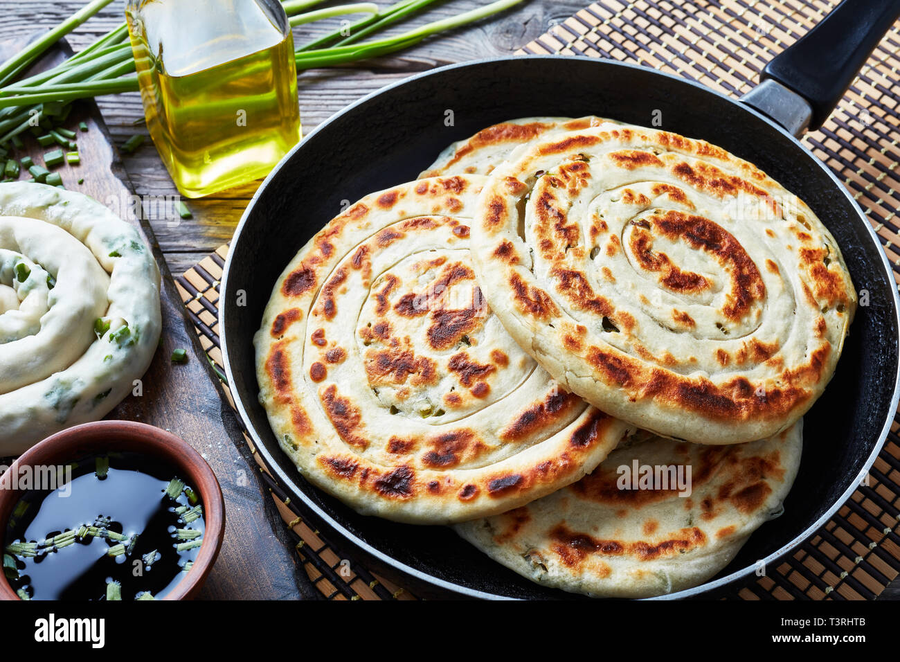 close-up of hot Chinese green onion Pancakes in a skillet with an ...